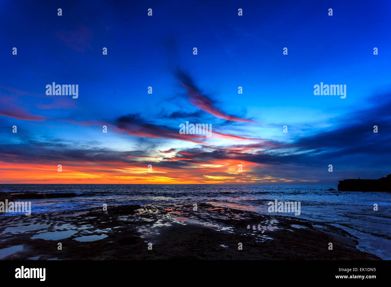 Dramatic Sunset with reflection in Bali, Indonesia Stock Photo - Alamy