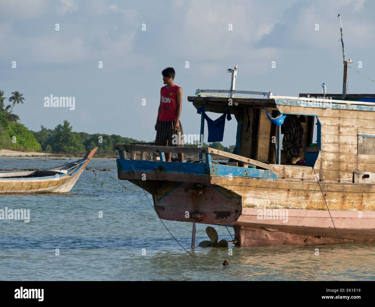 Fisherman on a boat in Bintan island, Sumatra, Indonesia Stock Photo ...