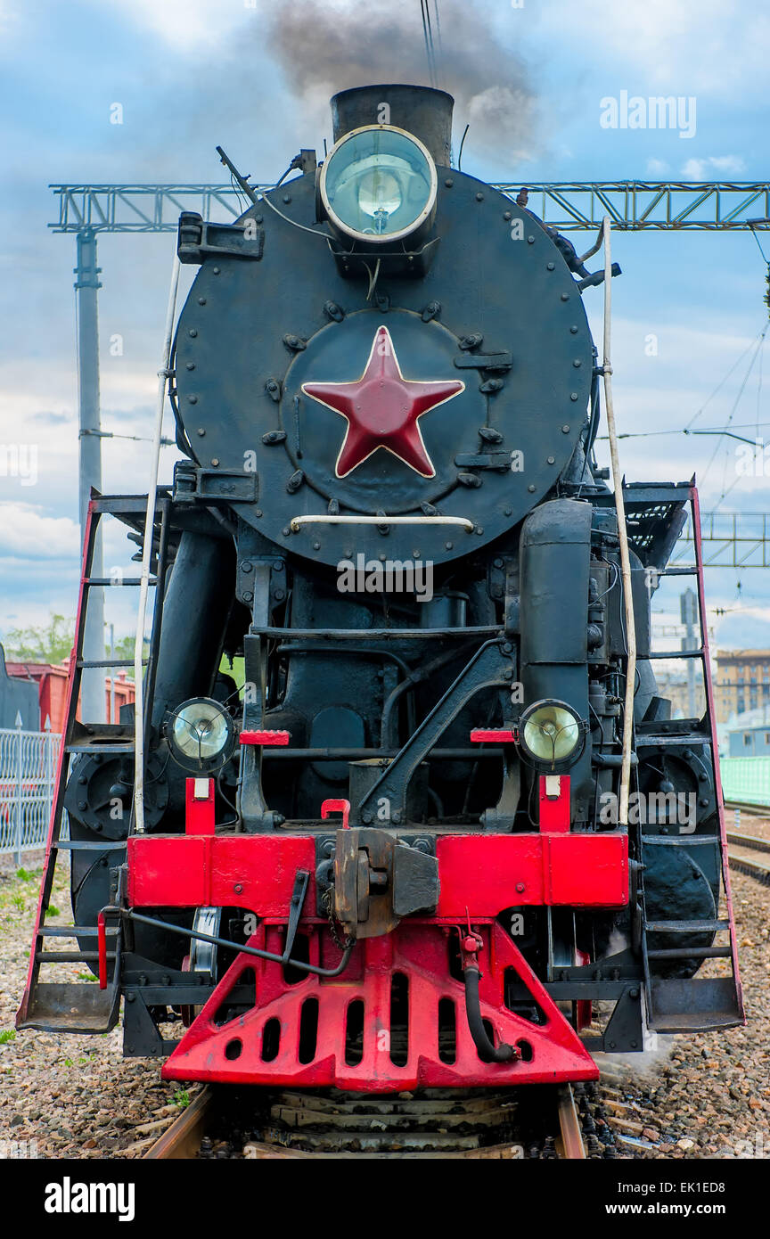 old steam locomotive with smoke travels on rails Stock Photo - Alamy