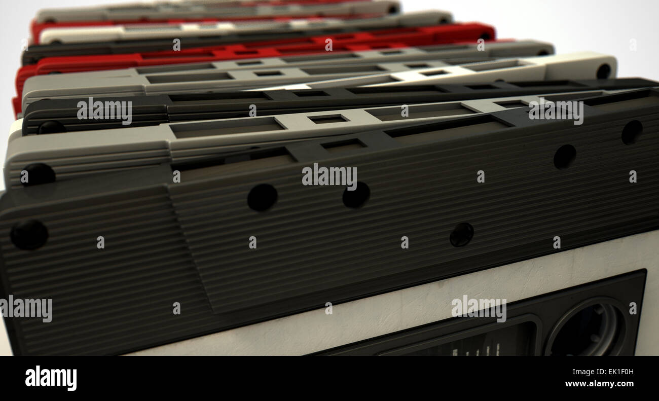 A close up view of a collection of vintage audio cassette tape lined up ...