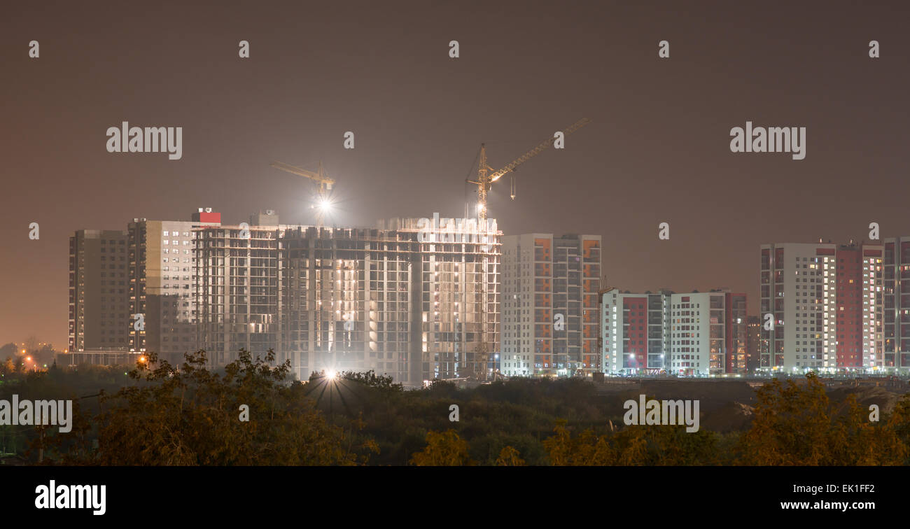 Construction sites and homes. Night view Stock Photo - Alamy