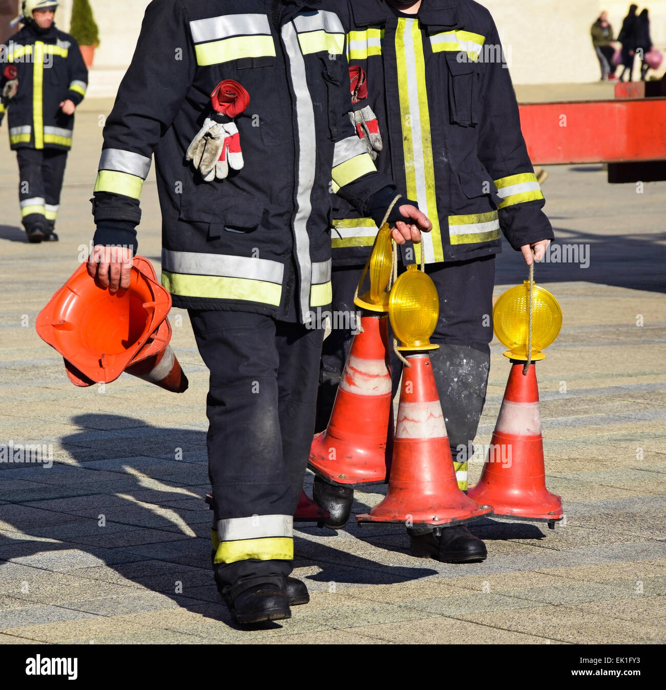 Firefighters walk with traffic cones Stock Photo - Alamy