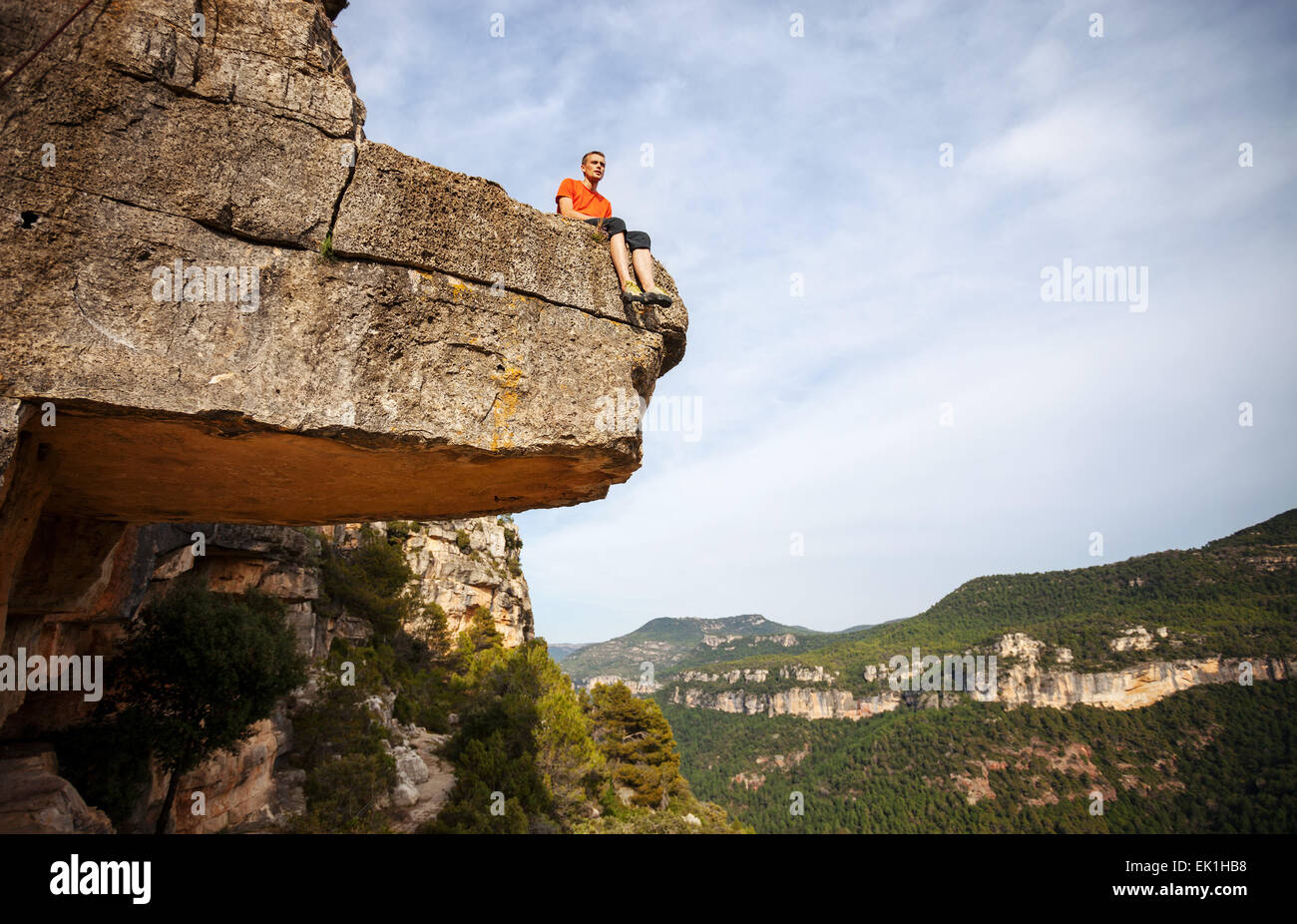 Young man sitting by cliff edge hi-res stock photography and images - Alamy