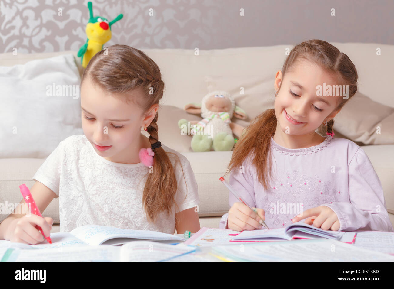 Girls write in note pads Stock Photo - Alamy