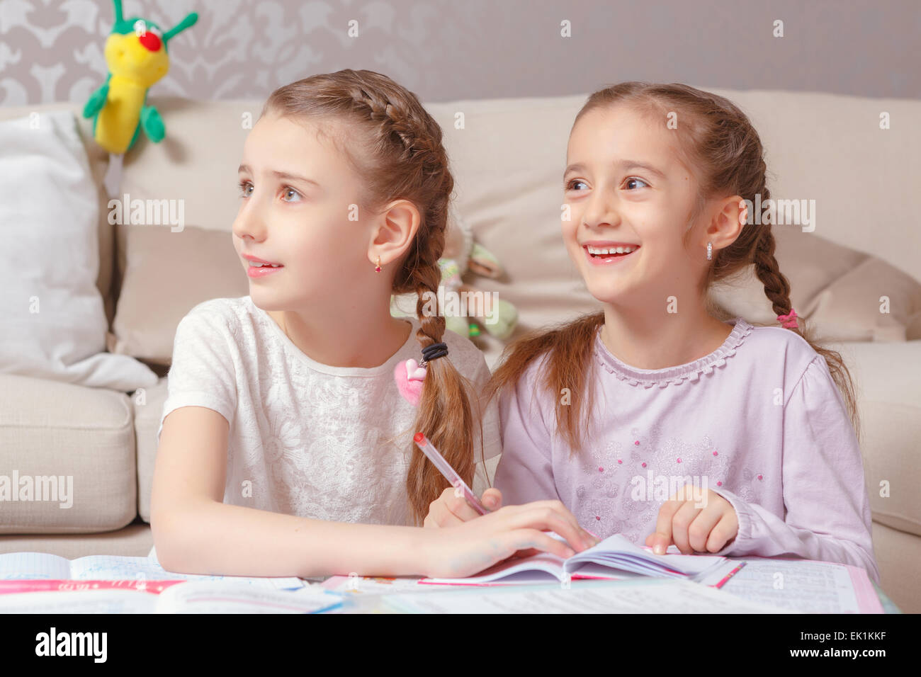 Girls write in note pads Stock Photo - Alamy