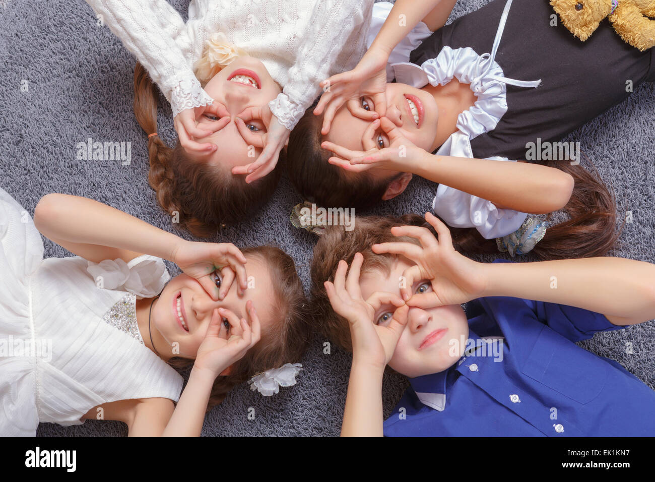 Kids lay on the floor Stock Photo - Alamy