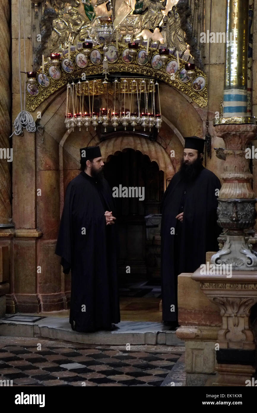 Greek Orthodox clergymen stand at the entrance to the Edicule or ...