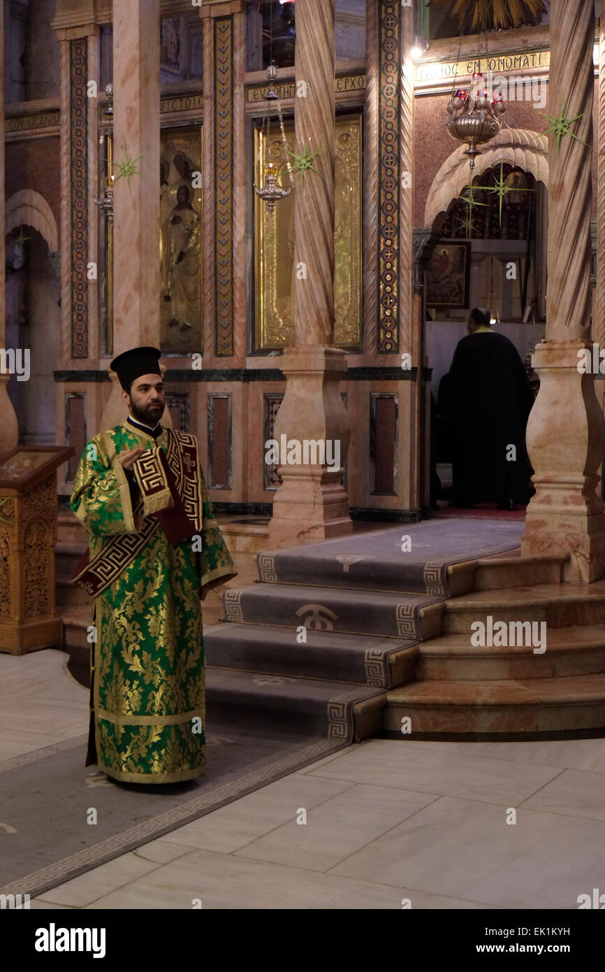 A Greek Orthodox priest taking part in a daily procession during Holy ...