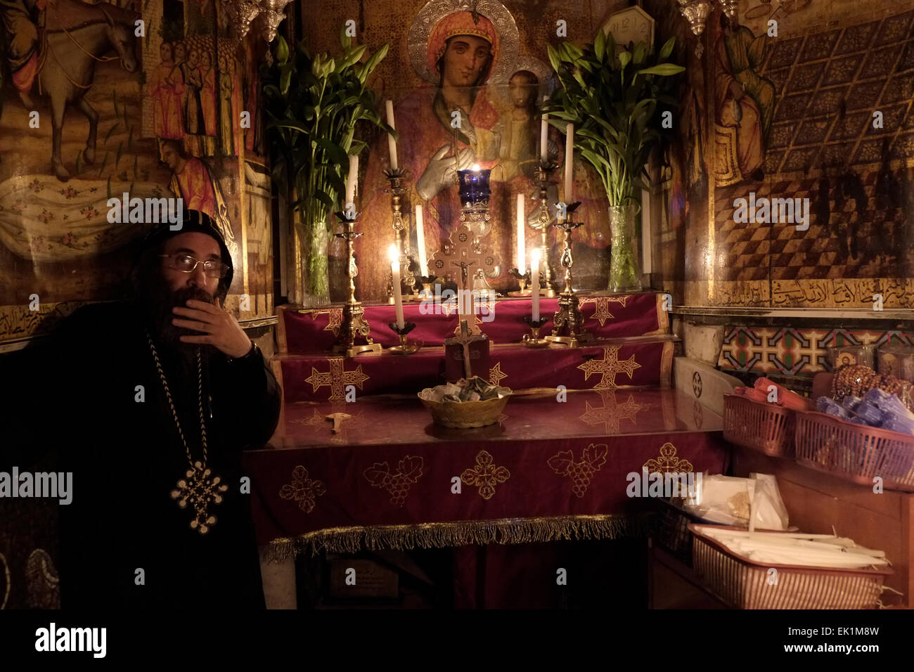 A Coptic Orthodox priest sits inside the small Coptic Chapel which ...