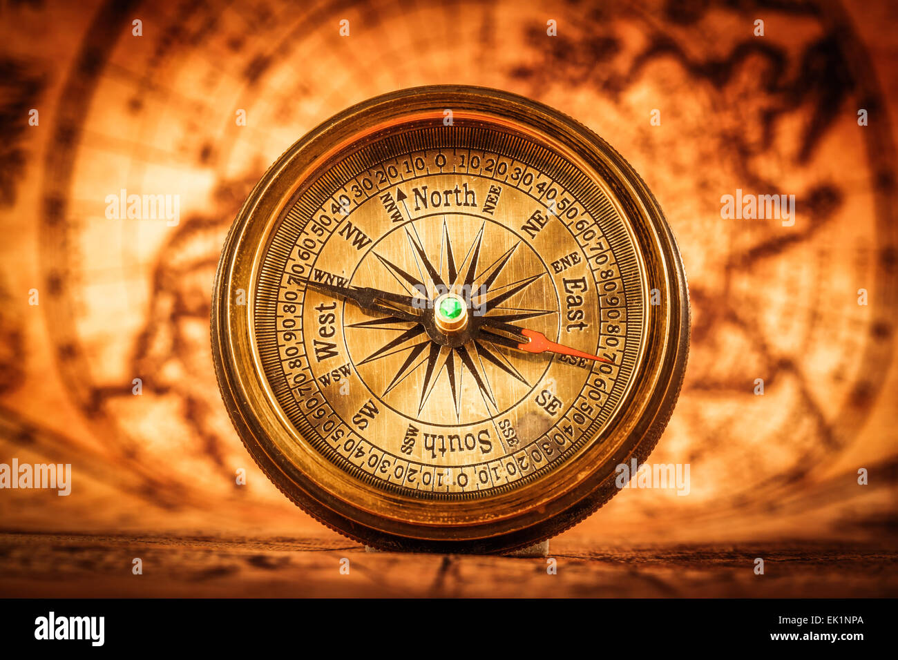 Vintage still life. Vintage compass lies on an ancient world map Stock ...