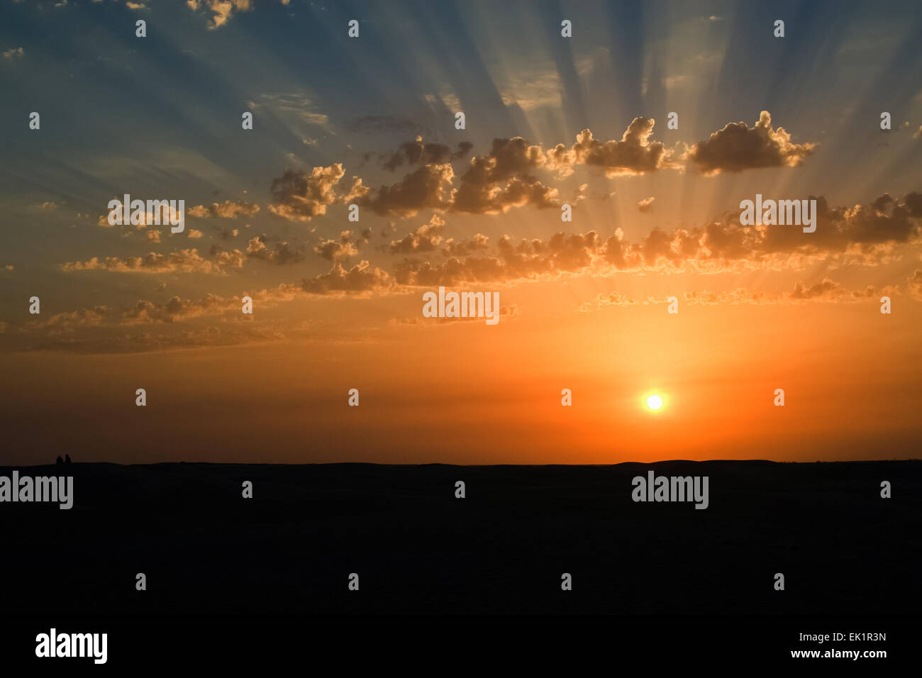 Sunset in the desert Stock Photo - Alamy