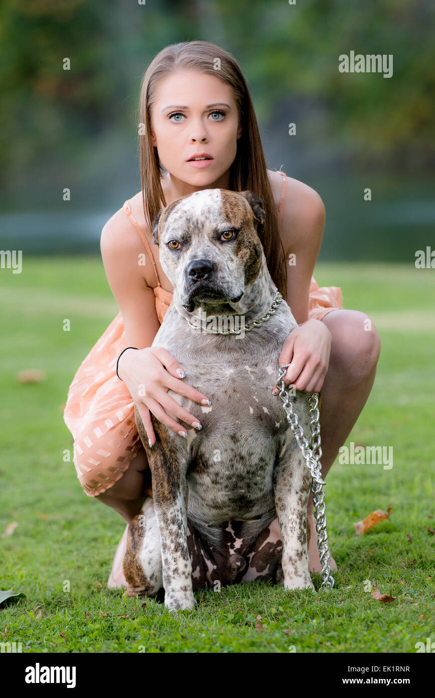 Cute young female poses with dog, late afternoon in the park Stock ...