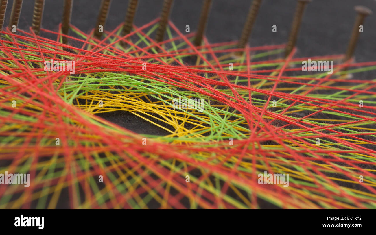 Display of colorful threads on a black panel Stock Photo - Alamy