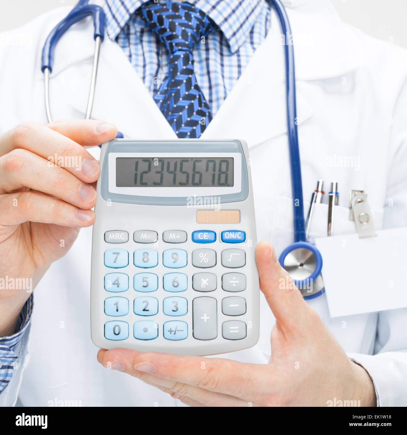 Medical doctor holding calculator in hands - health care concept Stock ...