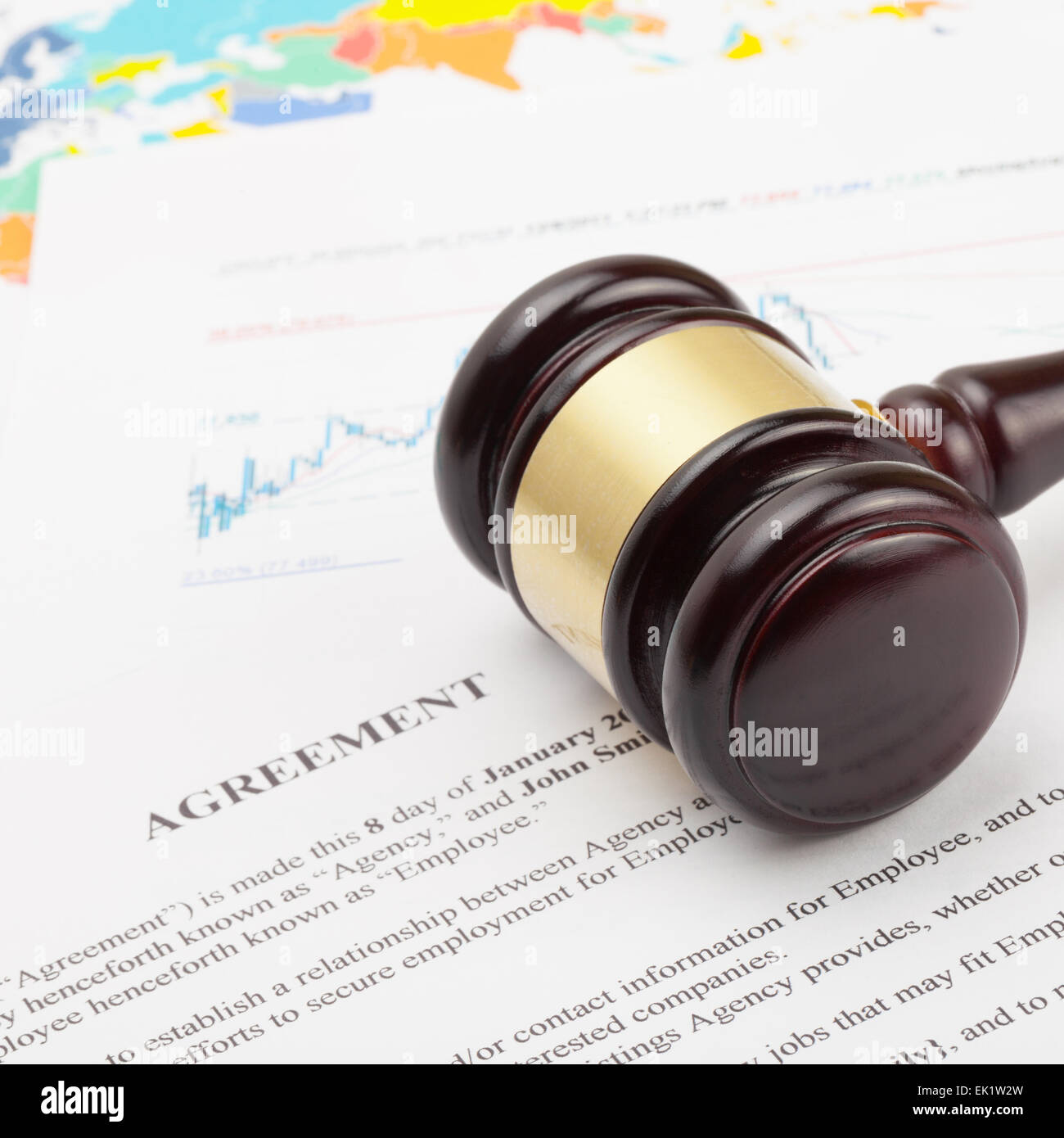Judge's gavel over agreement documents and world map - close up shot ...