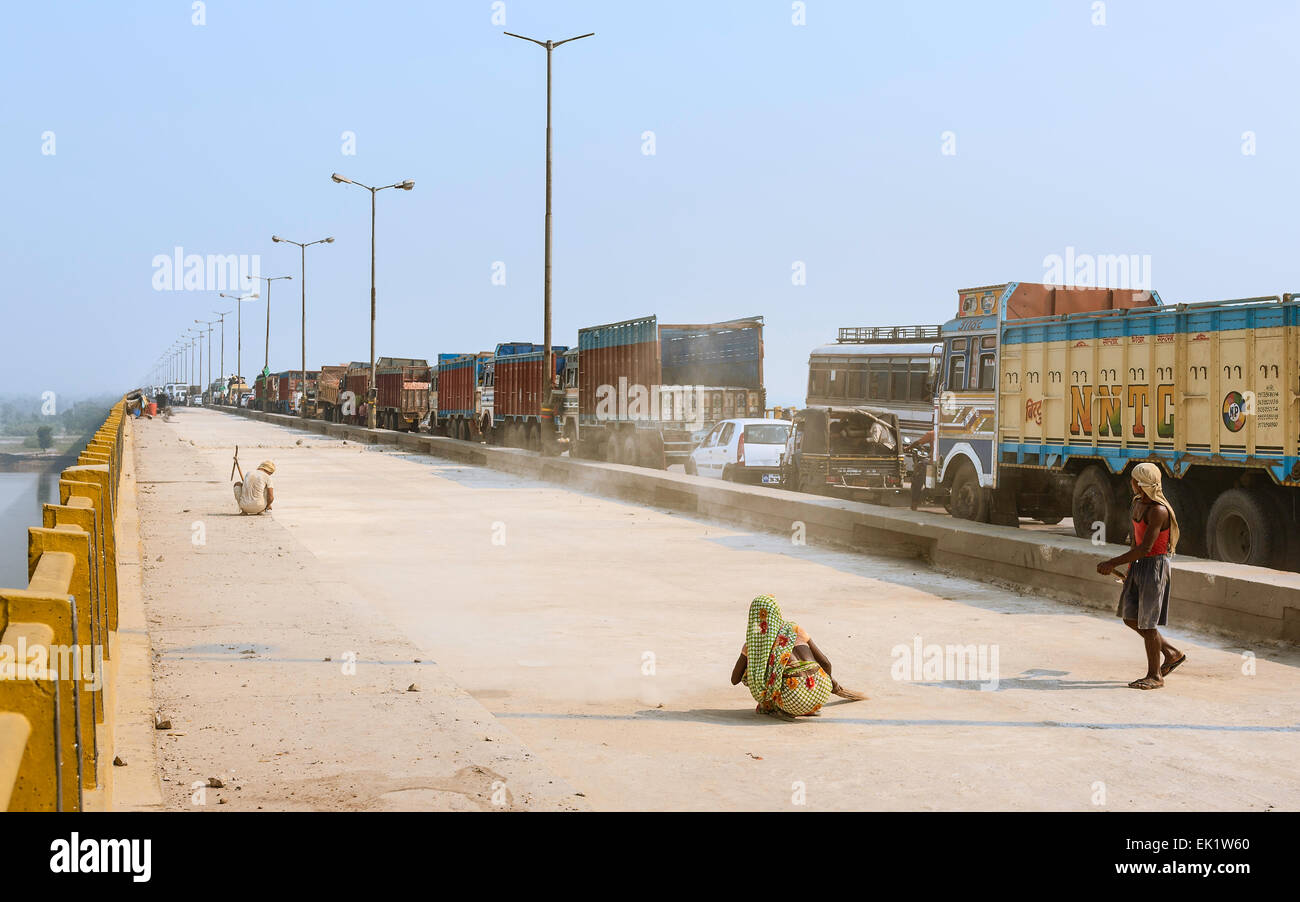 Construction workers prepare a lane of the 10 km long Mahatma Gandhi ...