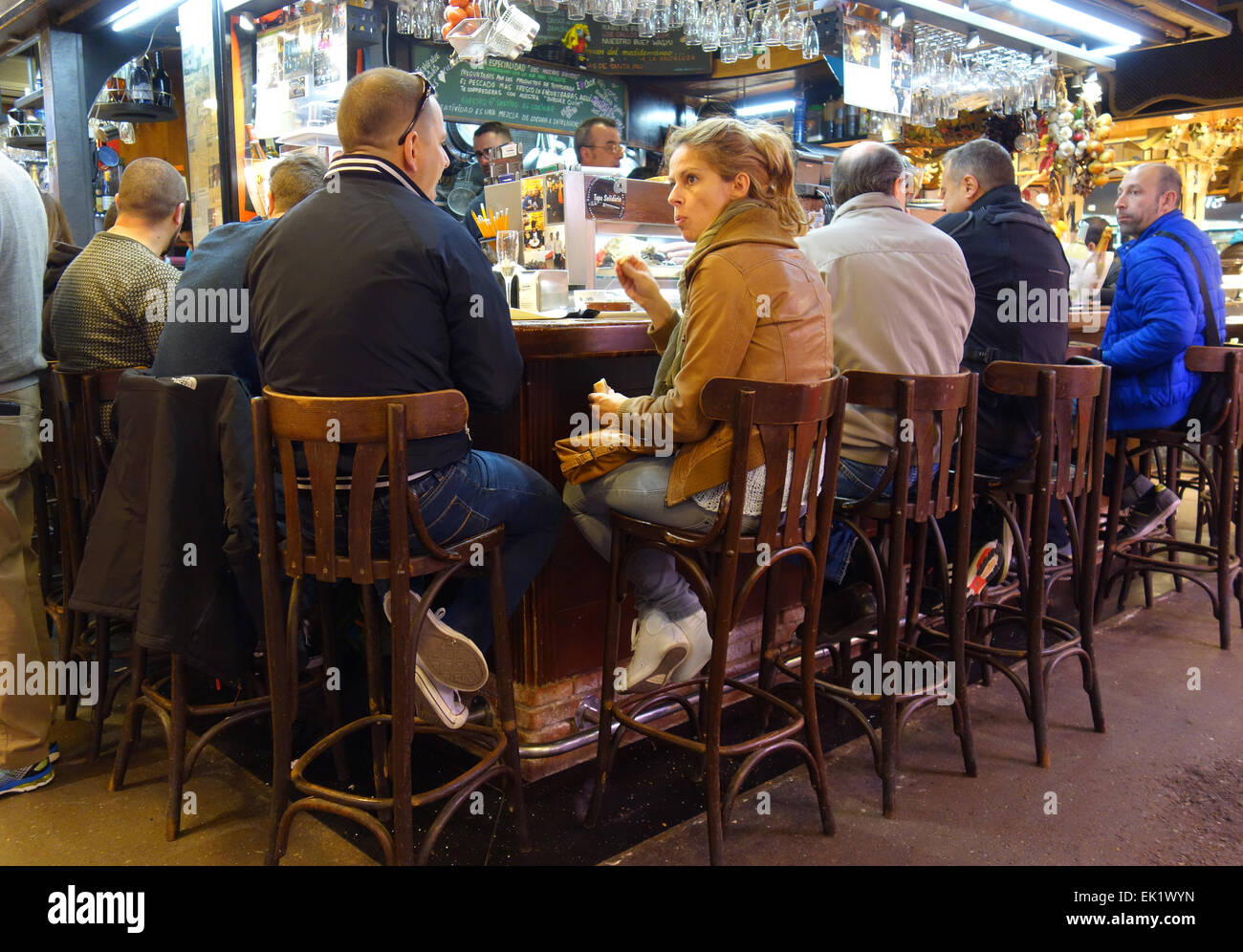 People sitting at bar restaurant inside la Boqueria market, Barcelona ...