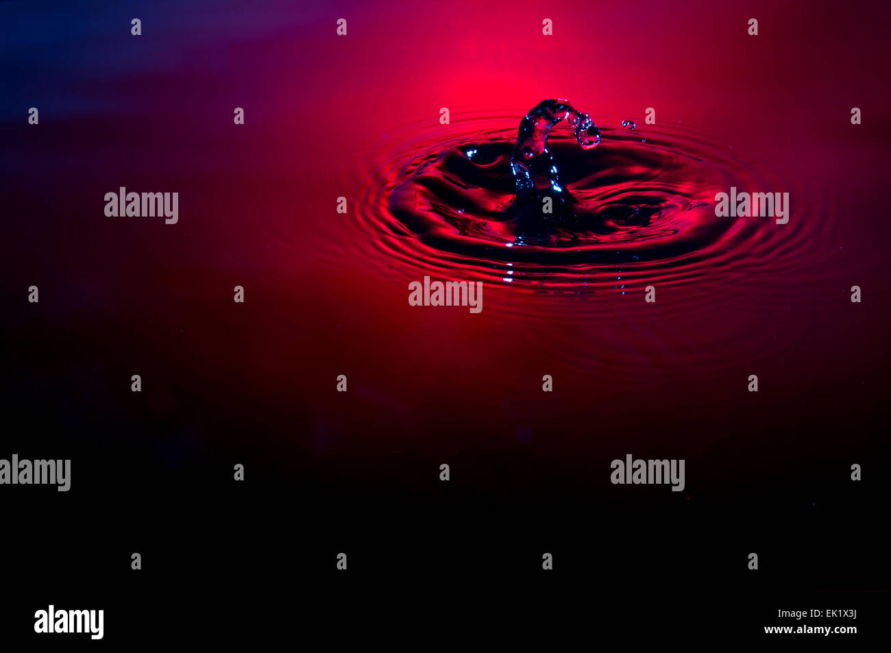 Drop of water splashing on surface Stock Photo - Alamy