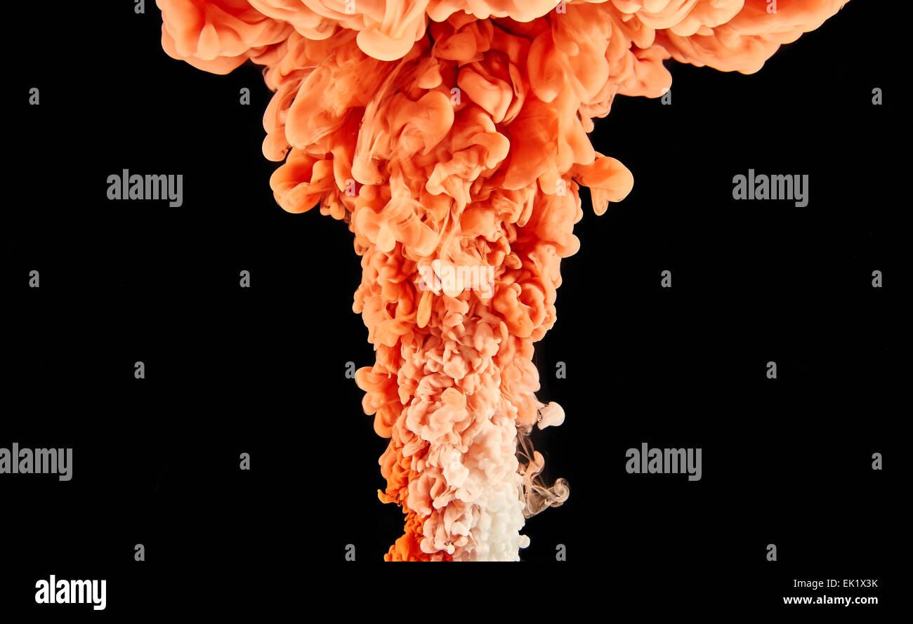 Clay colored ink making smoke patterns in water on black background ...