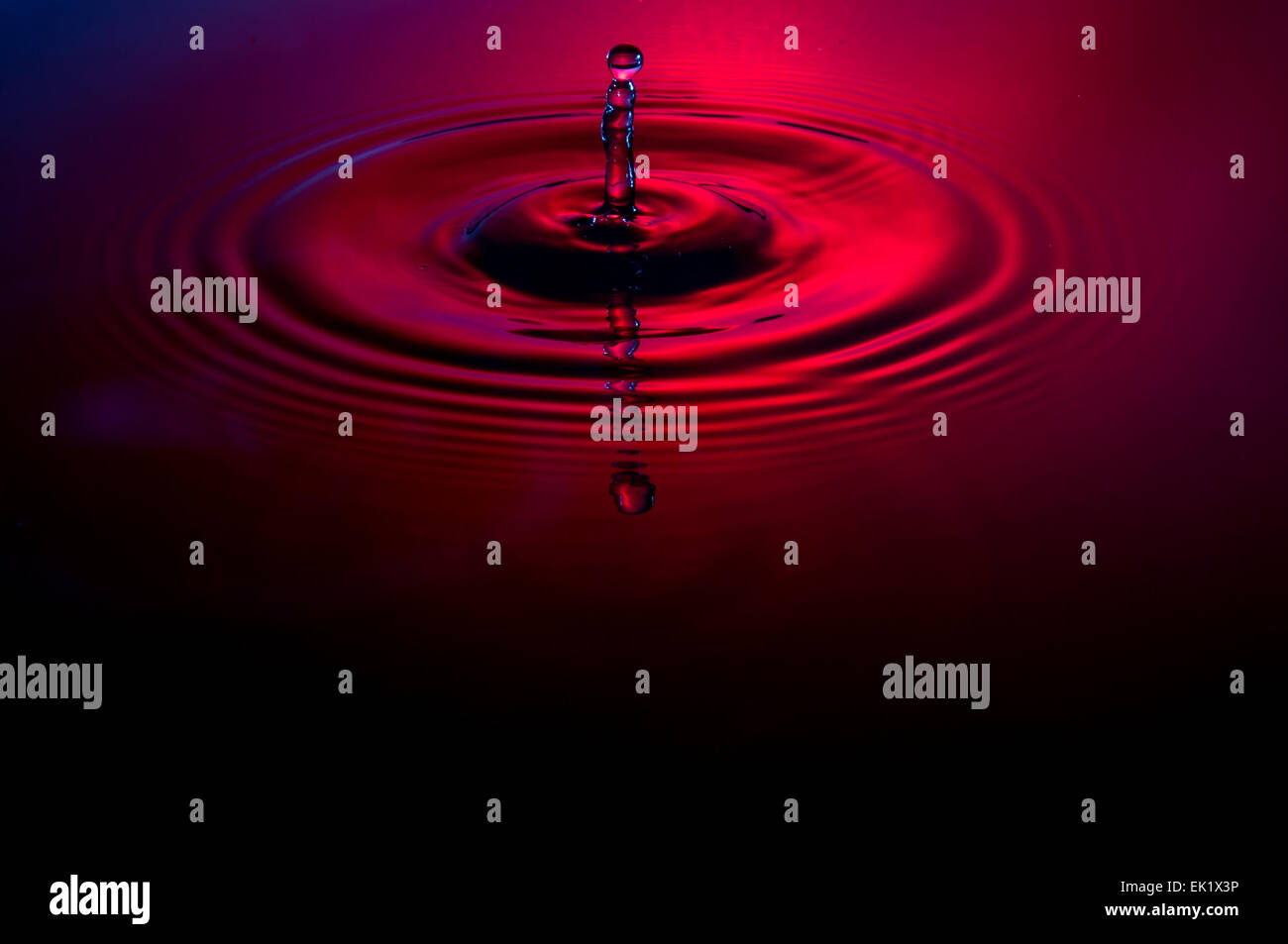 Drop of water splashing on surface Stock Photo - Alamy