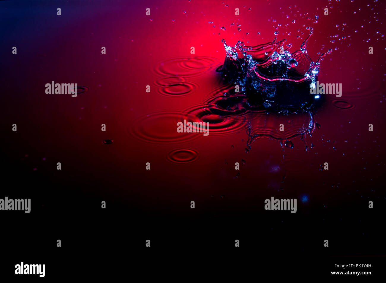Drop of water splashing on surface Stock Photo - Alamy