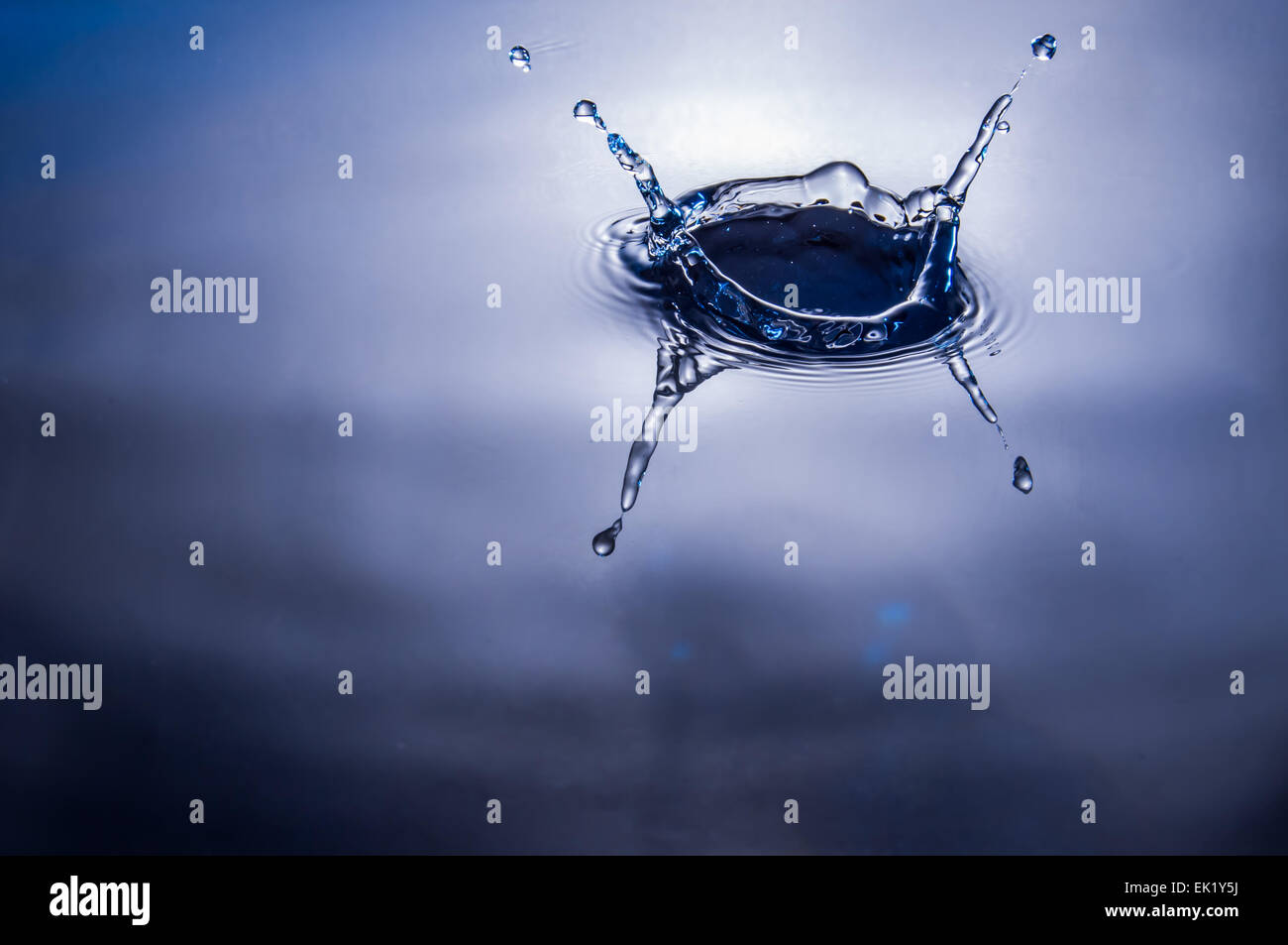 Drop of water splashing on surface Stock Photo - Alamy