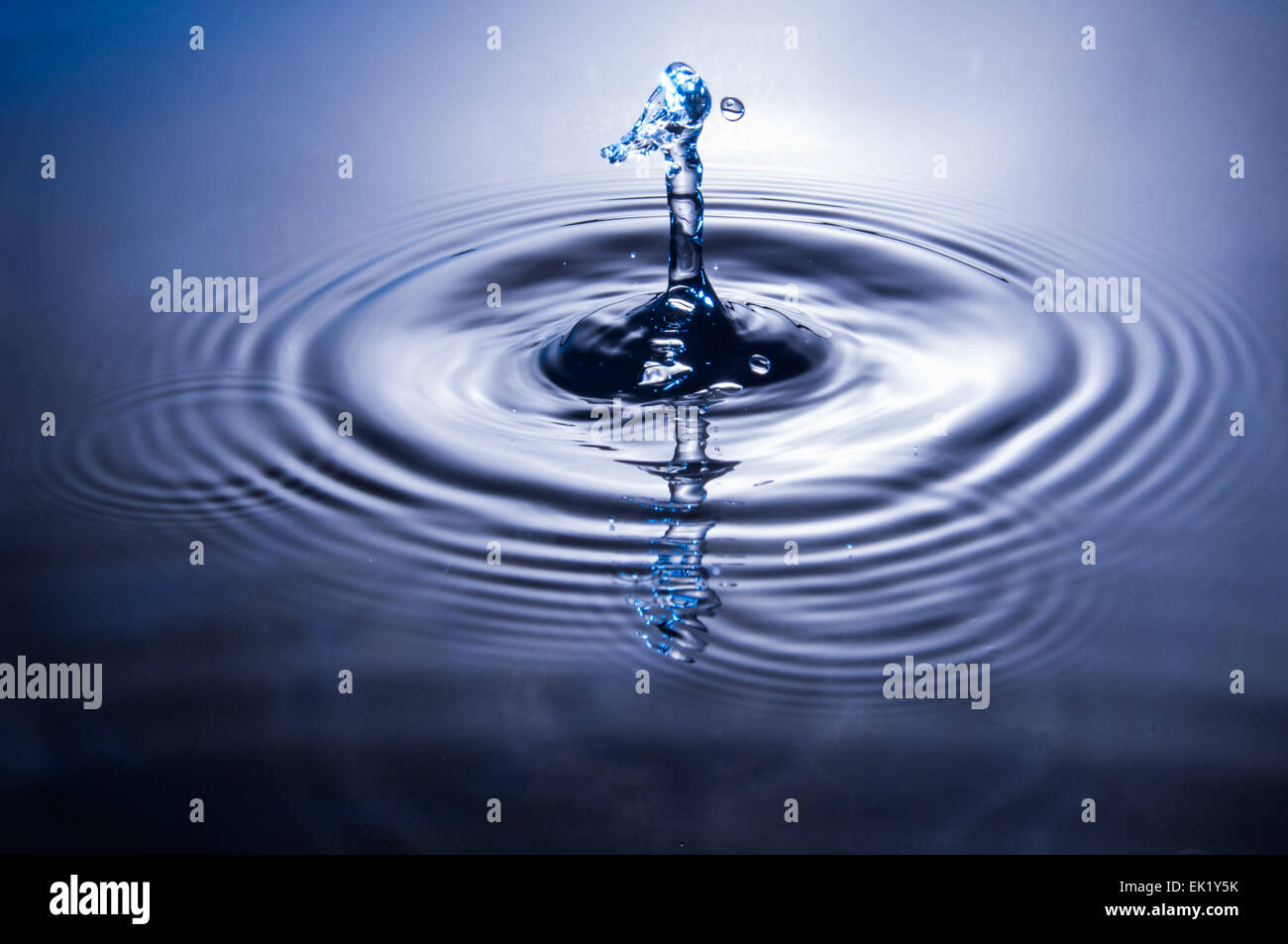 Drop of water splashing on surface Stock Photo - Alamy
