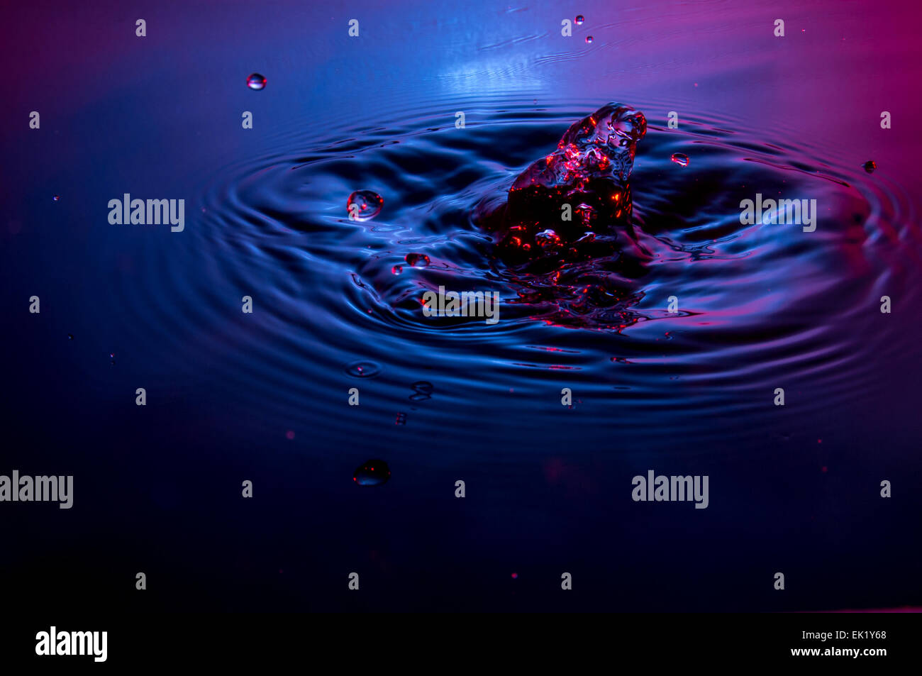 Drop of water splashing on surface Stock Photo - Alamy
