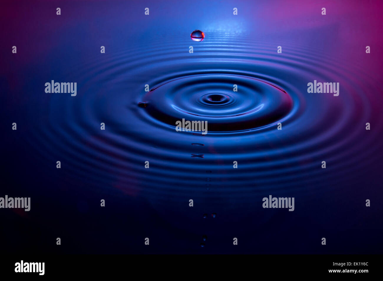 Drop of water splashing on surface Stock Photo - Alamy