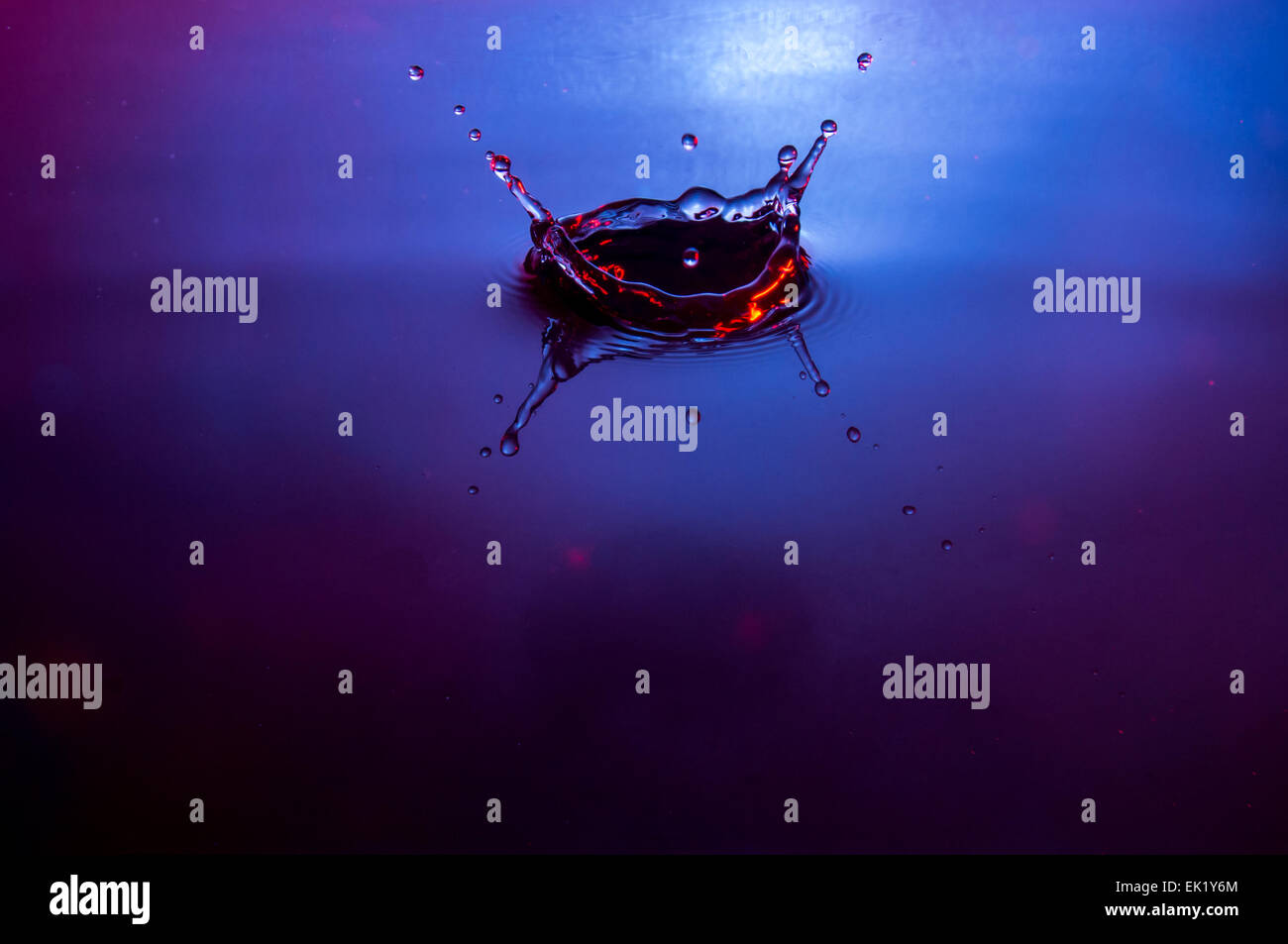 Drop of water splashing on surface Stock Photo - Alamy