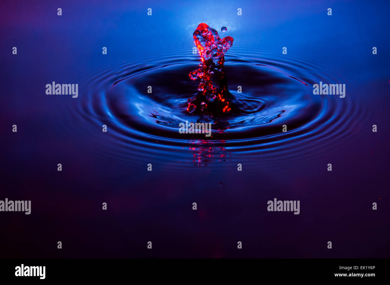 Drop of water splashing on surface Stock Photo - Alamy