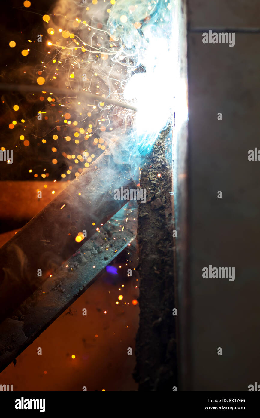 welding steel with spread spark lighting smoke Stock Photo - Alamy