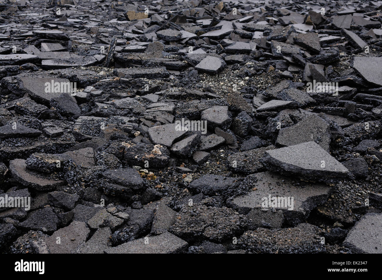 Area of black tarmac which has been broken up by severe trauma Stock ...