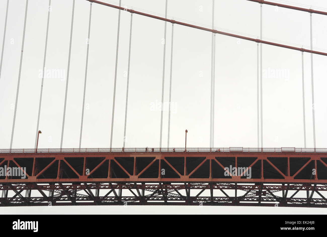Grey sky view, from bay ferry, Golden Gate Bridge roadway, deck trusses ...