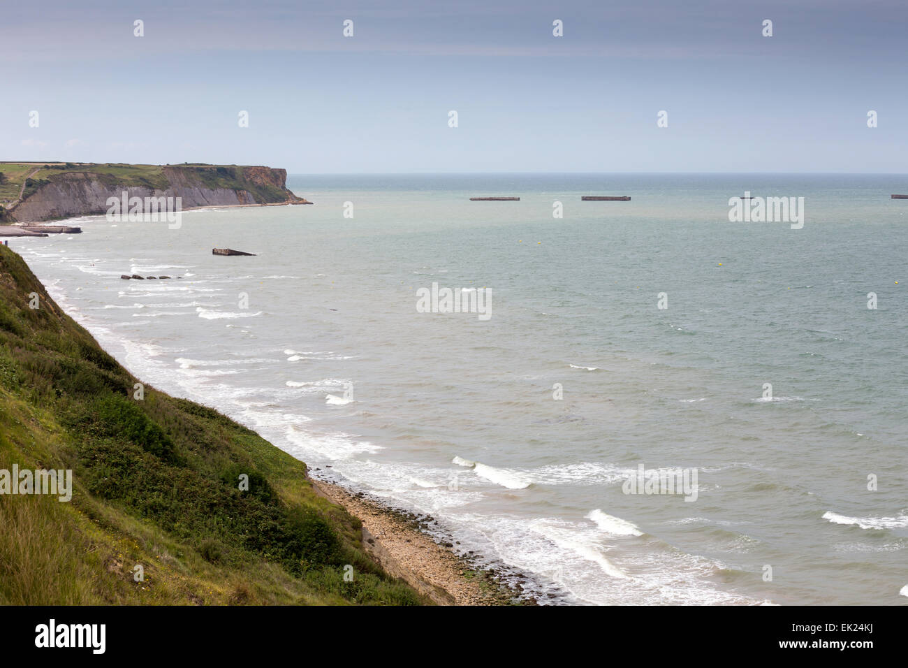 Arromanches les Bains beach with the remains of the Mulberry harbour in ...