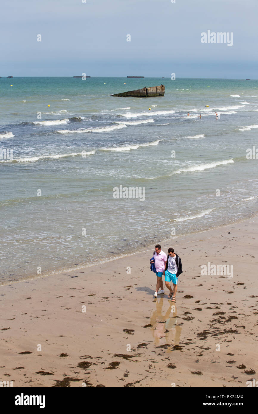 Arromanches les Bains beach with the remains of the Mulberry harbour in ...