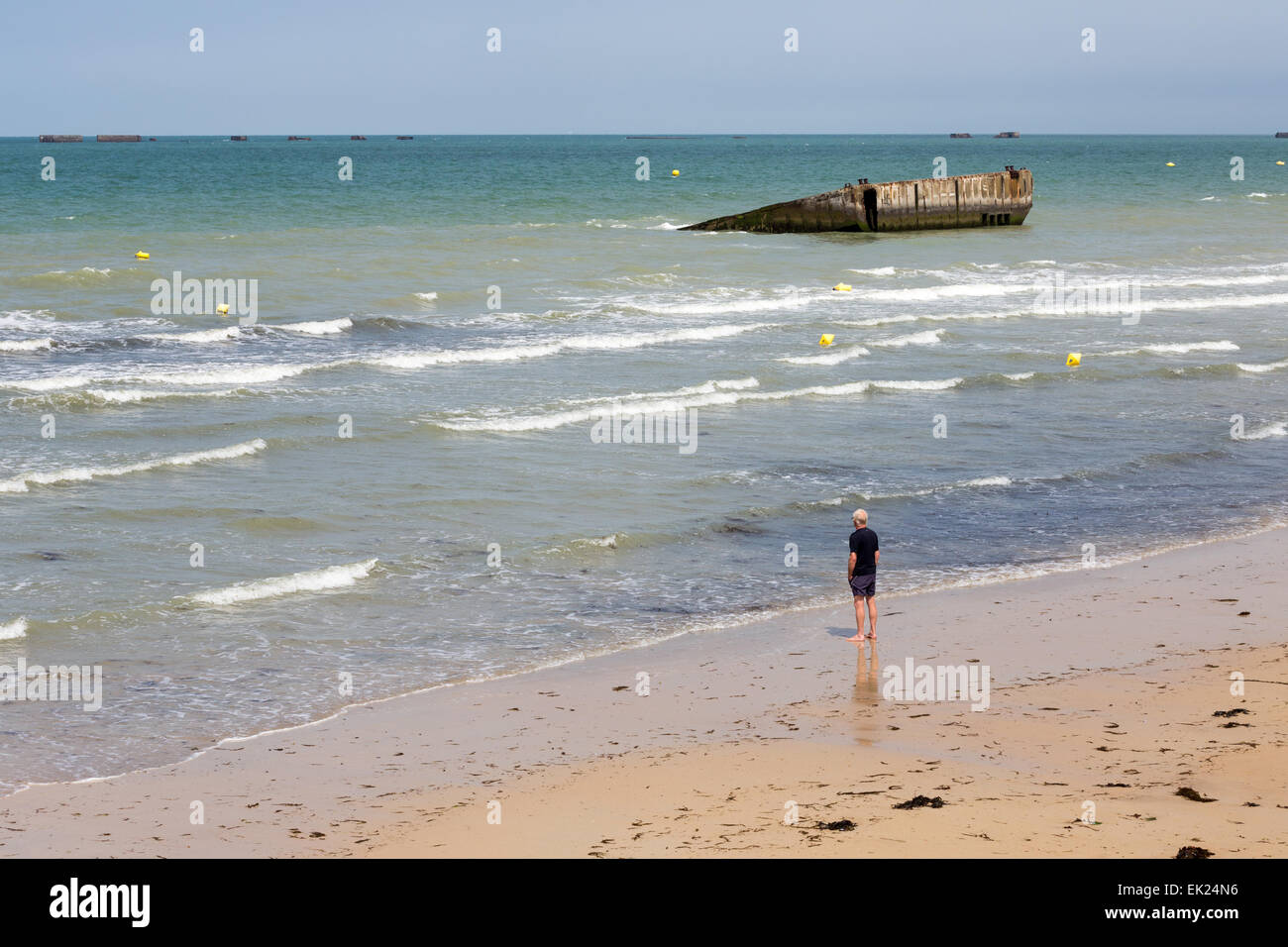 Arromanches les Bains beach with the remains of the Mulberry harbour in ...