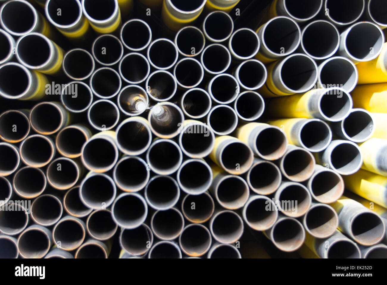 Pile of yellow, industrial, metal pipes Stock Photo - Alamy