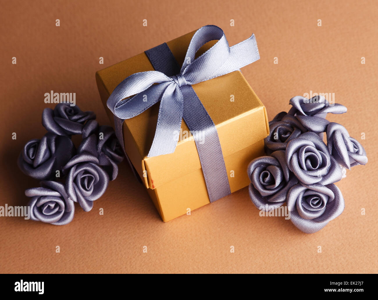 grey flowers and golden gift box Stock Photo - Alamy