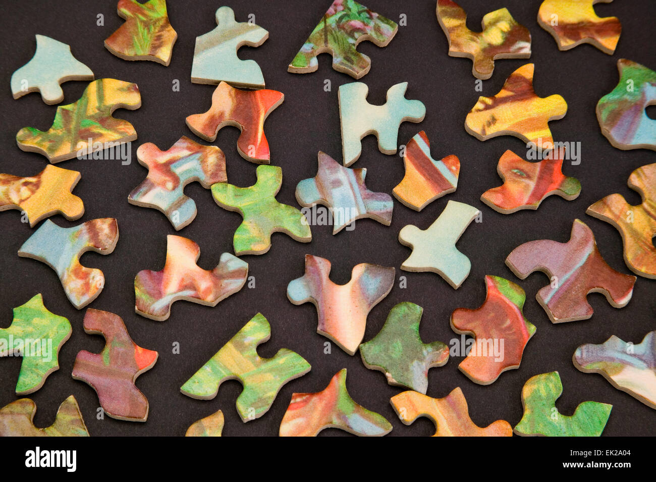 Puzzle pieces strewn about in a studio setting Stock Photo - Alamy