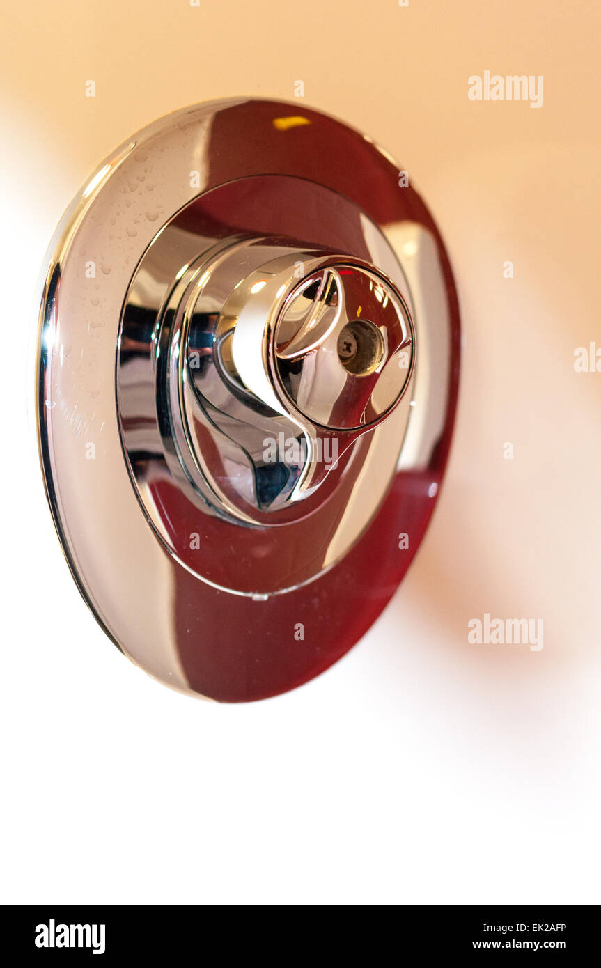 Showerhead water control knob mounted on white tiled wall Stock Photo ...