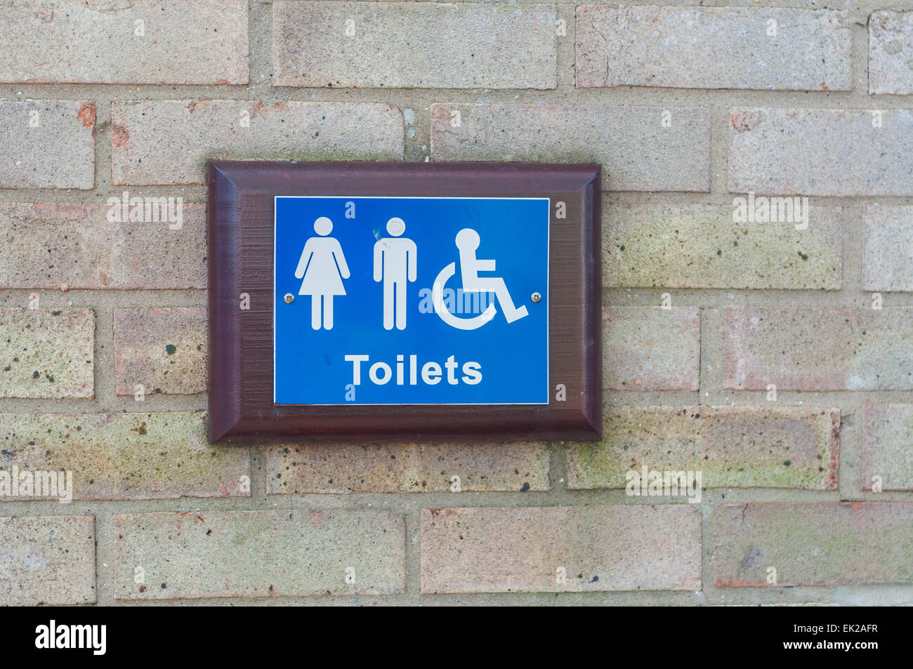 Toilets sign for public restroom mounted on a brick wall Stock Photo ...
