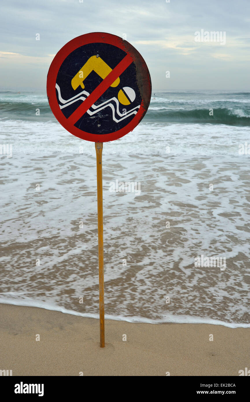 Sign on beach prohibiting swimming, communicating to bathers dangerous ...