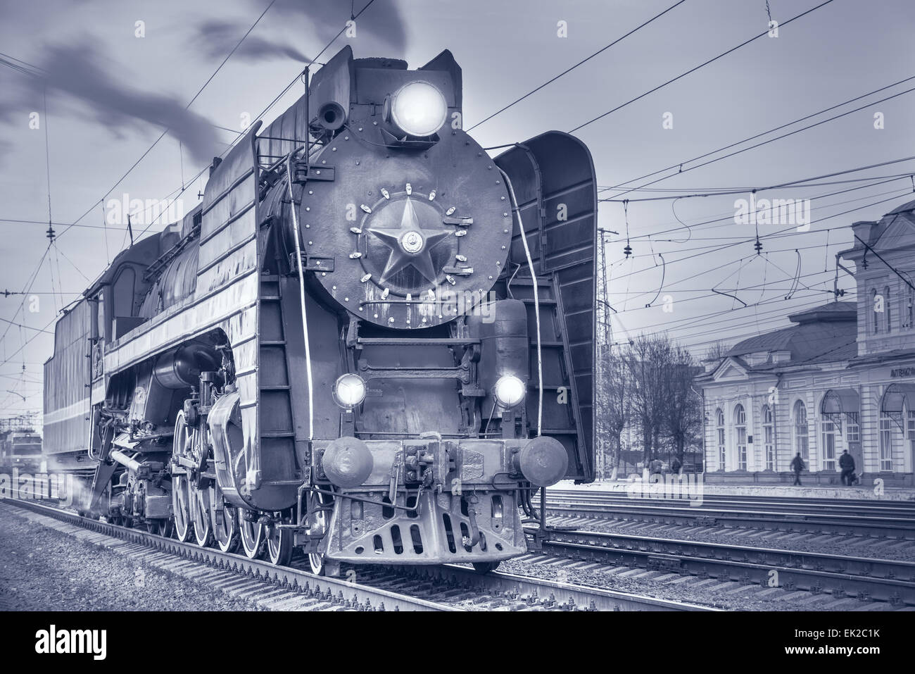 Retro steam locomotive stands on the station at evening time Stock ...