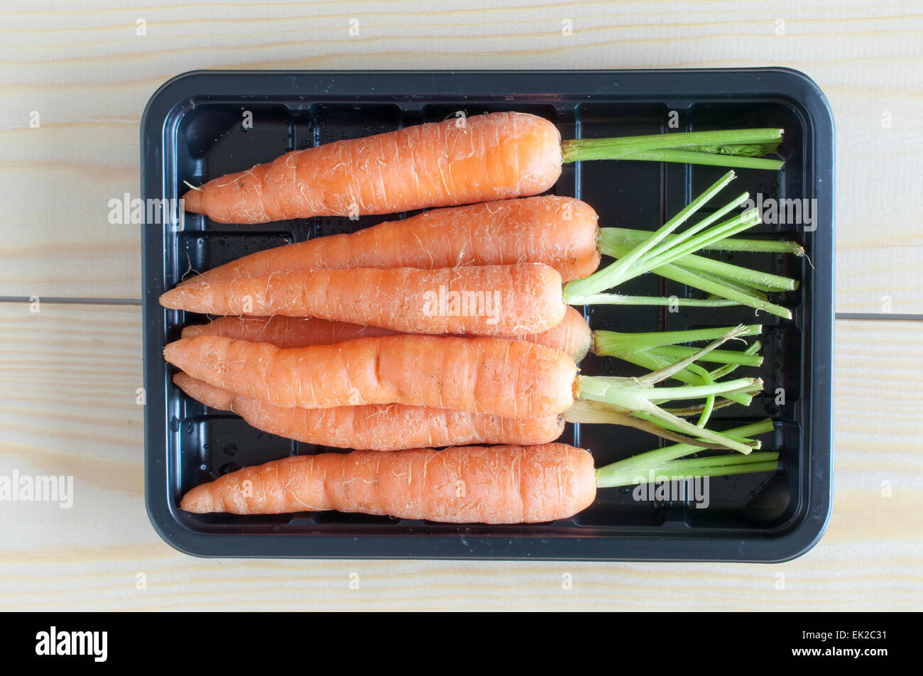 Close up of baby carrots in a black container Stock Photo - Alamy