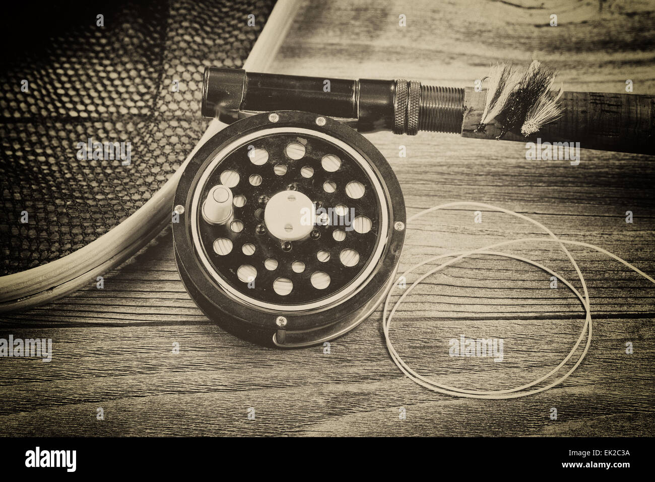 Vintage concept with grain of an antique fly fishing reel, rod, landing ...