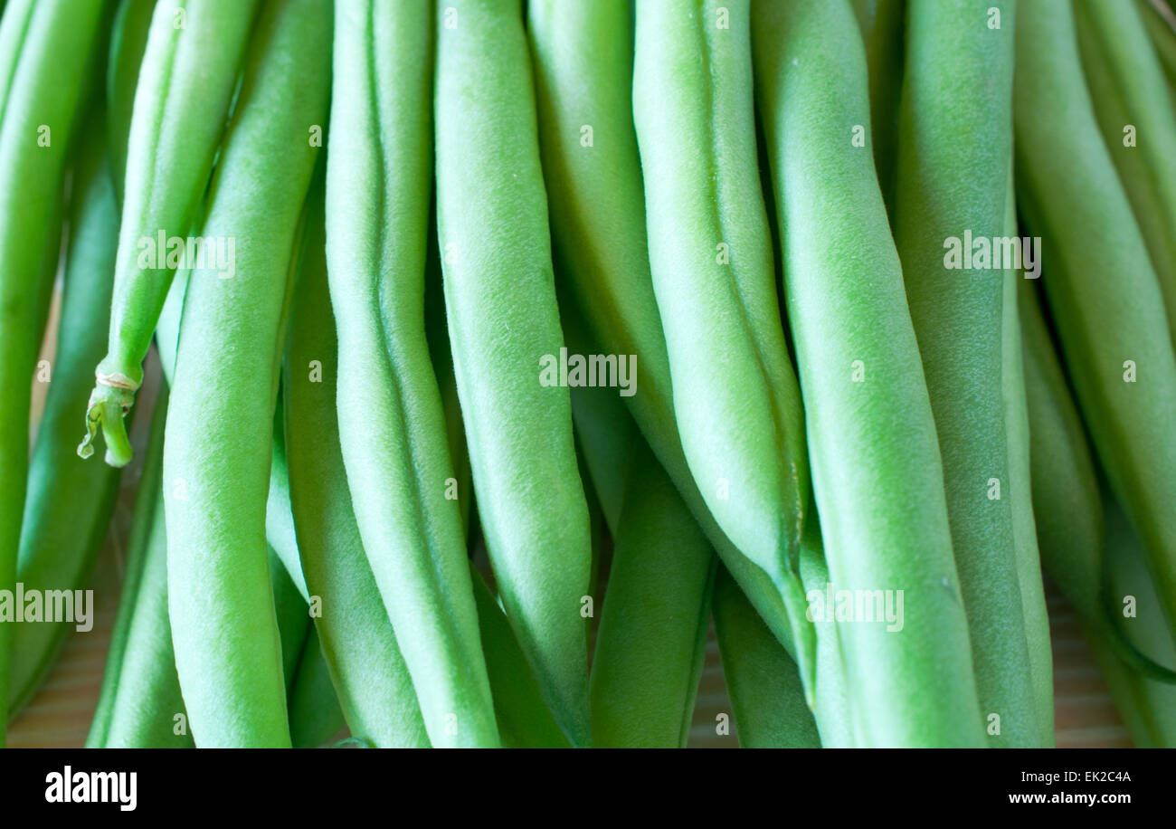Bunch of green beans layed out on wooden background Stock Photo - Alamy