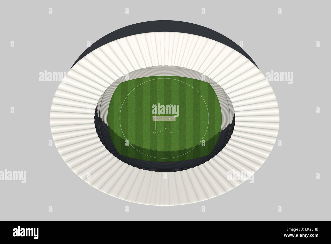 A cricket stadium with a pitch on a marked green grass field in the ...