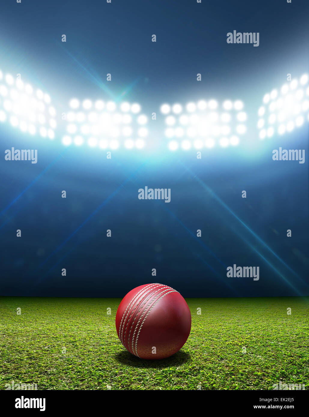 A cricket stadium with a red leather cricket ball on an unmarked green ...