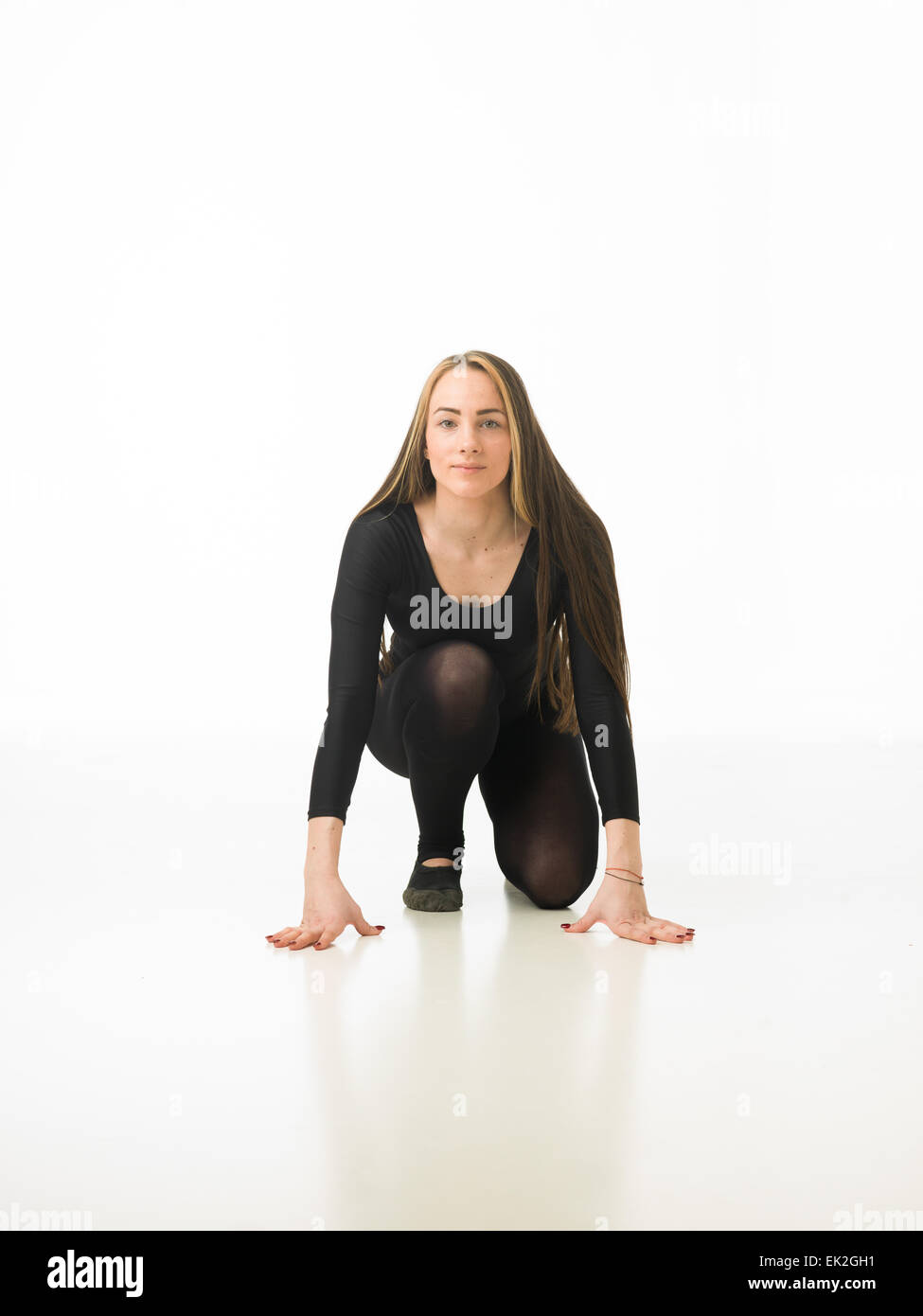beautiful ballet dancer sitting on studio floor looking in front of the ...